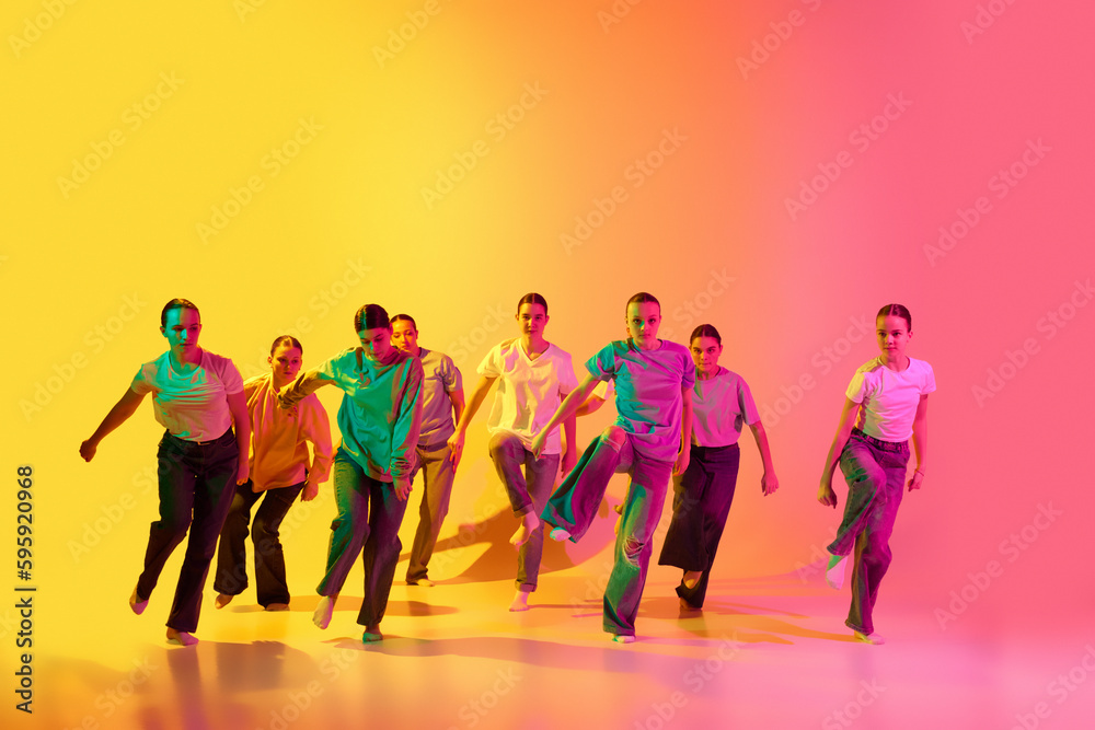 Portrait with group of teenagers, young dancers jumping together over ...