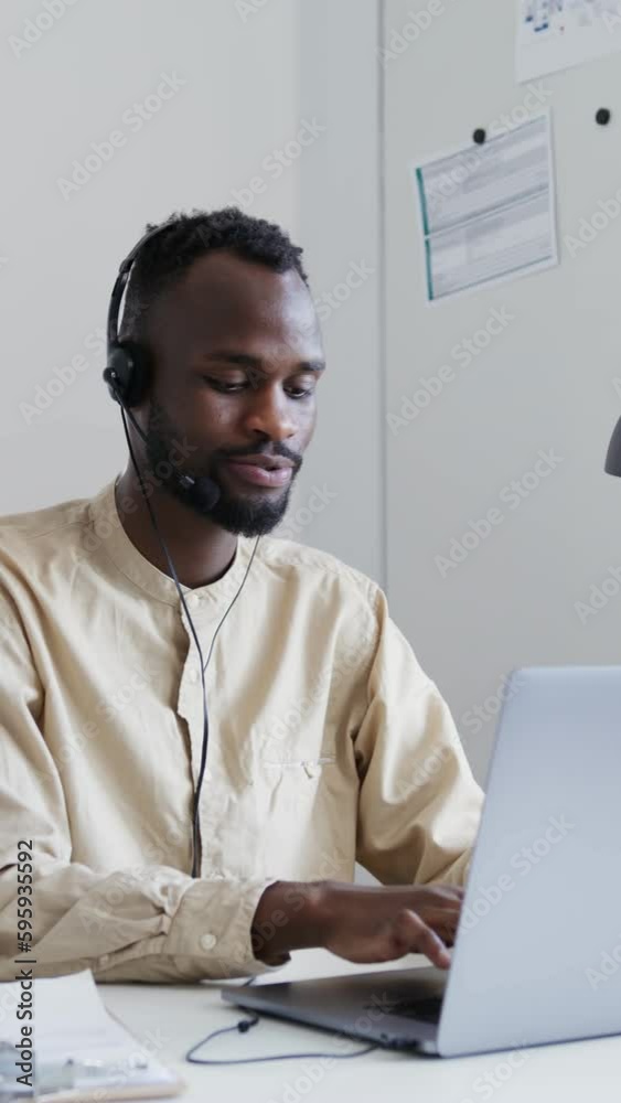 black guy with a beard in a shirt with a short afro hairstyle speaks ...