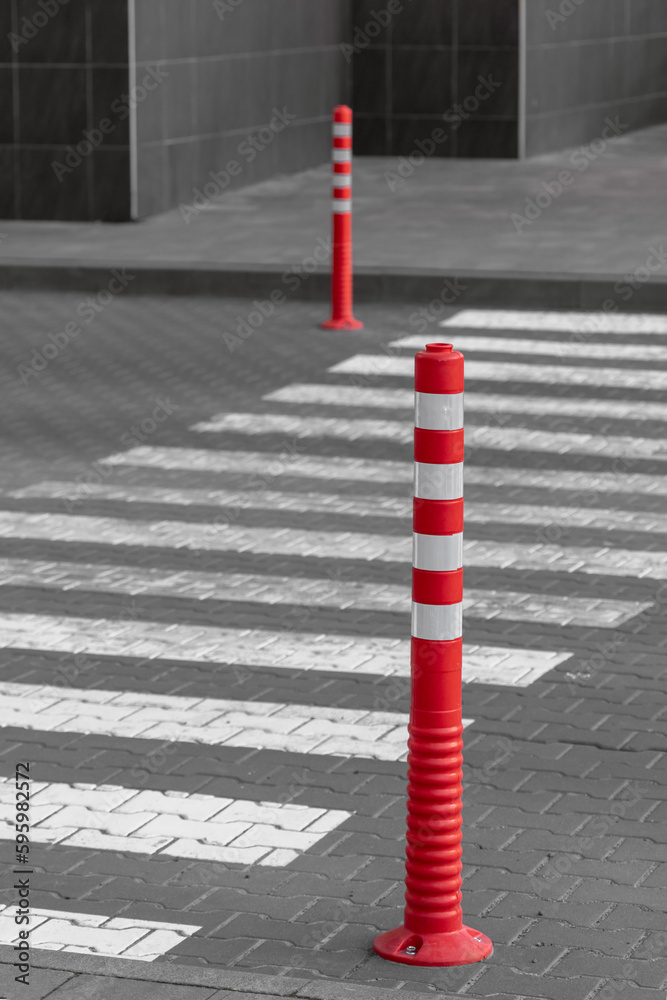 Empty pedestrian crossing and rubber signal posts. Red rubber column ...