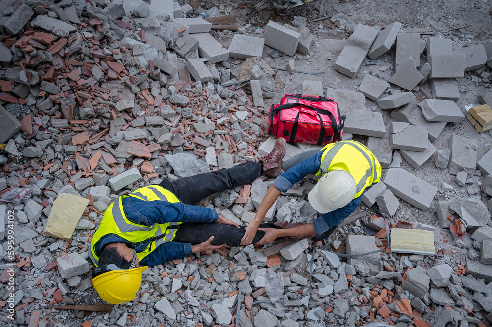 Young Asian builder falls from a height at a construction site. An ...