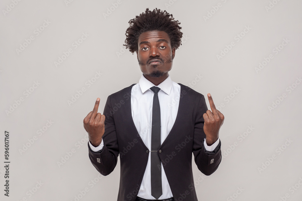 Impolite displeased man with Afro hairstyle shows middle finger, being ...