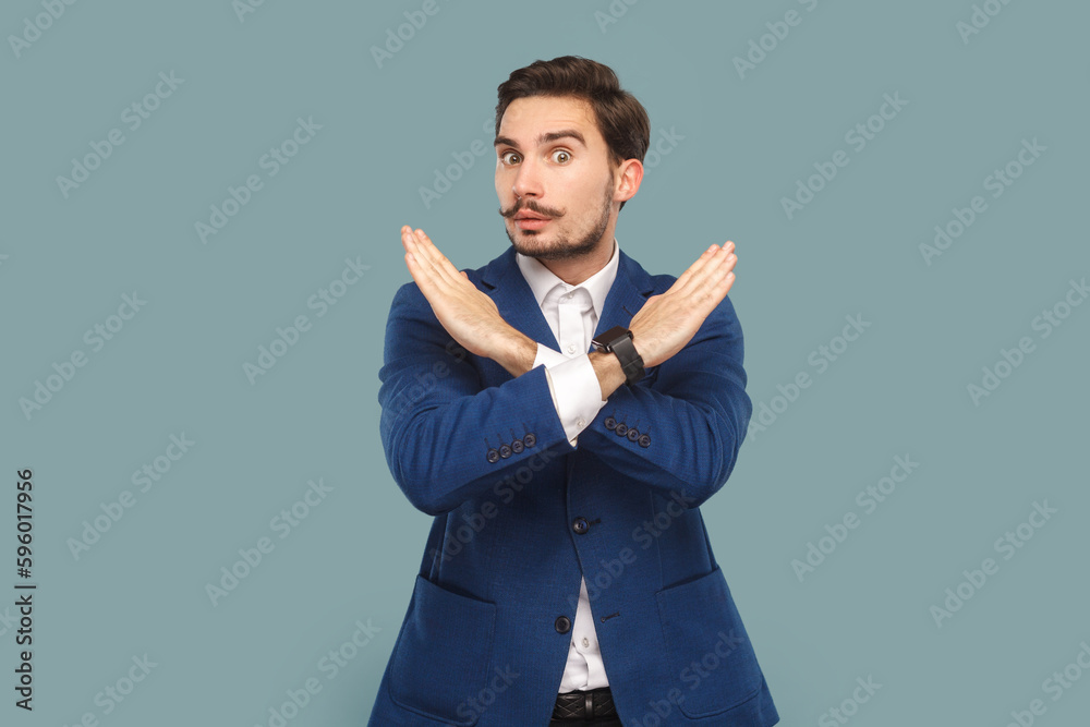 Serious strict man with mustache standing showing x sign, no way ...