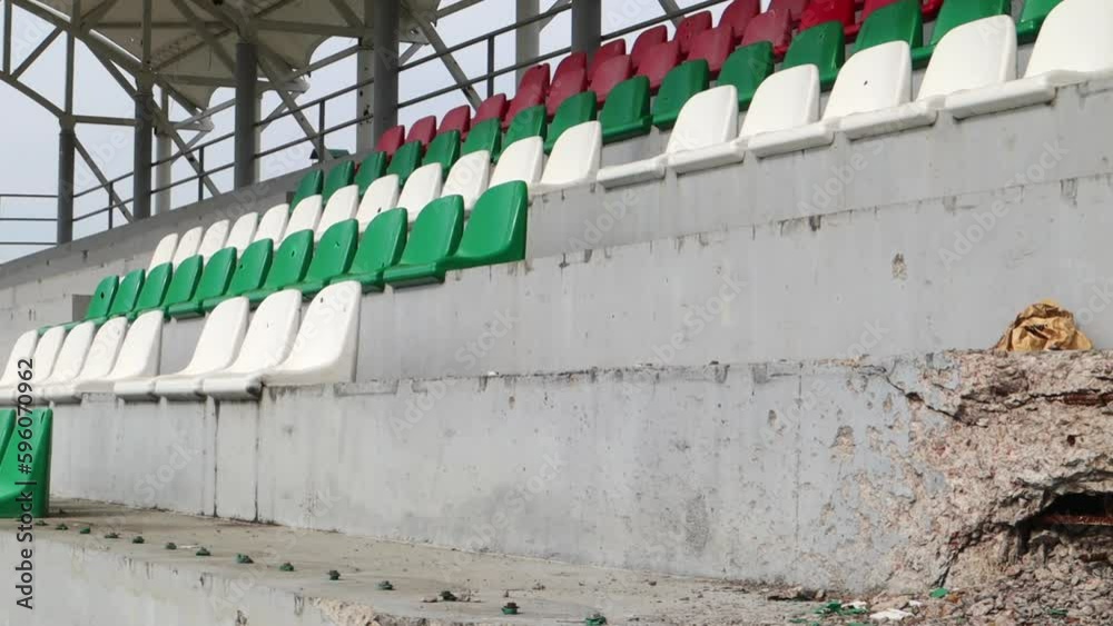 War in Ukraine. Broken plastic benches for fans on the podium, in a ...