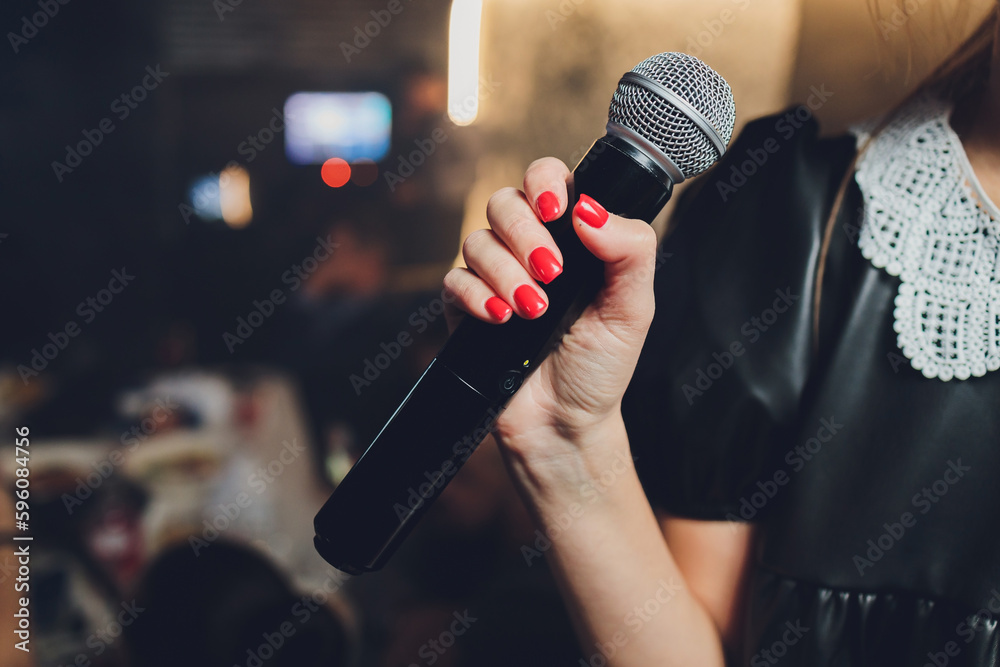 Microphone and unrecognizable female singer close up. Cropped image of ...