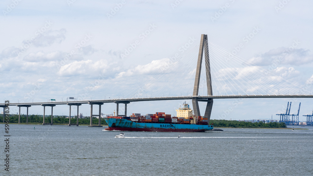 Cargo ship passing under the Arthur Ravenel Jr. Bridge in Charleston ...