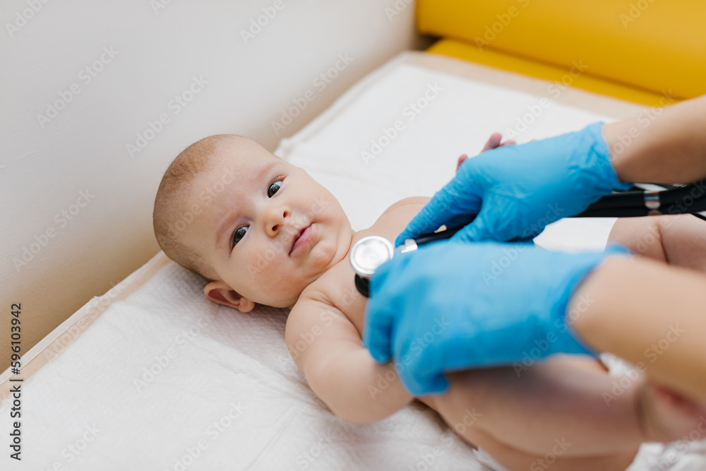 Pediatrician is examining a newborn baby in the hospital. Pediatrician ...