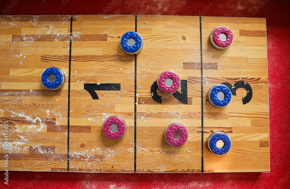 Shuffleboard is a game of precision and strategy, where players slide ...