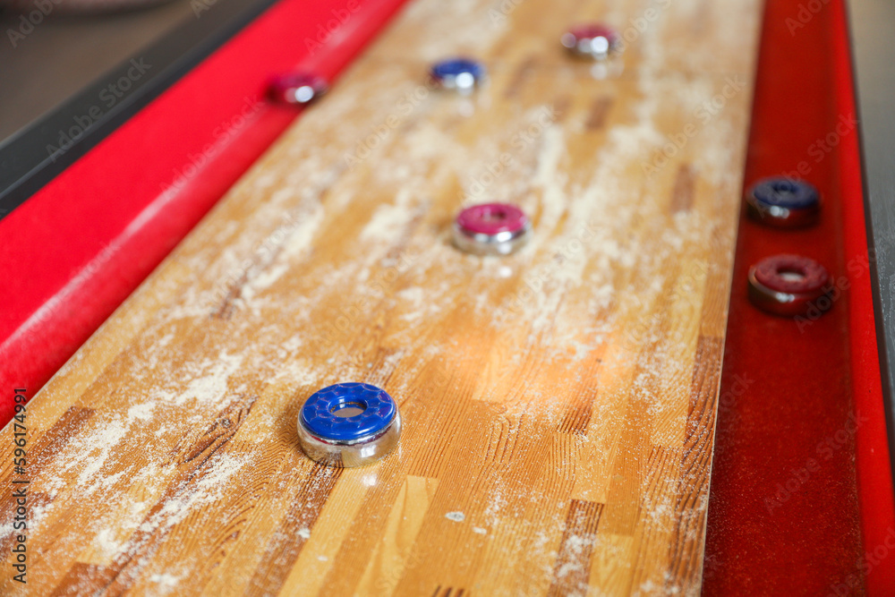 Shuffleboard is a game of precision and strategy, where players slide ...