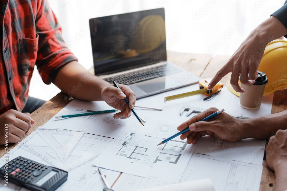 Architect or engineer are designing house, modifying plan, creating ...