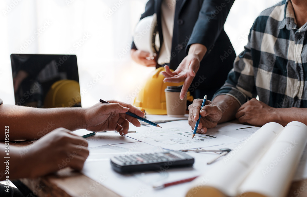 Architect or engineer are designing house, modifying plan, creating ...