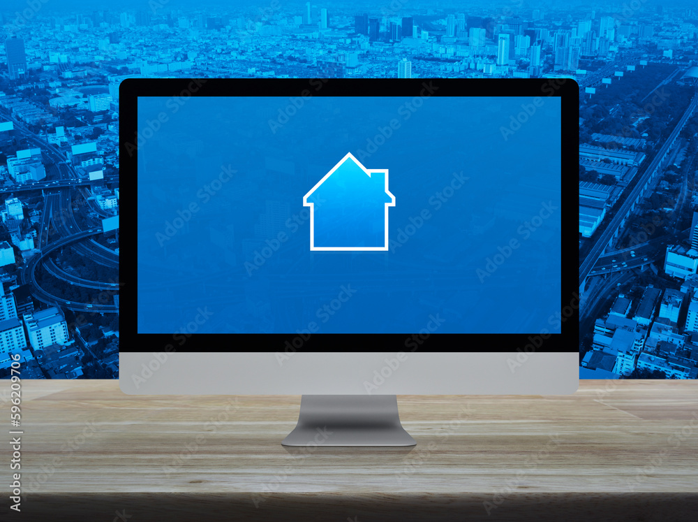 House icon with copy space on desktop modern computer monitor screen on ...
