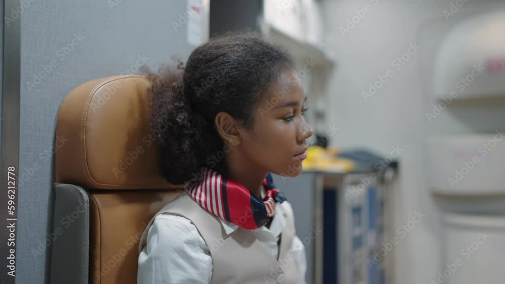 Woman african american stewardess, flight attendant in uniform sitting ...