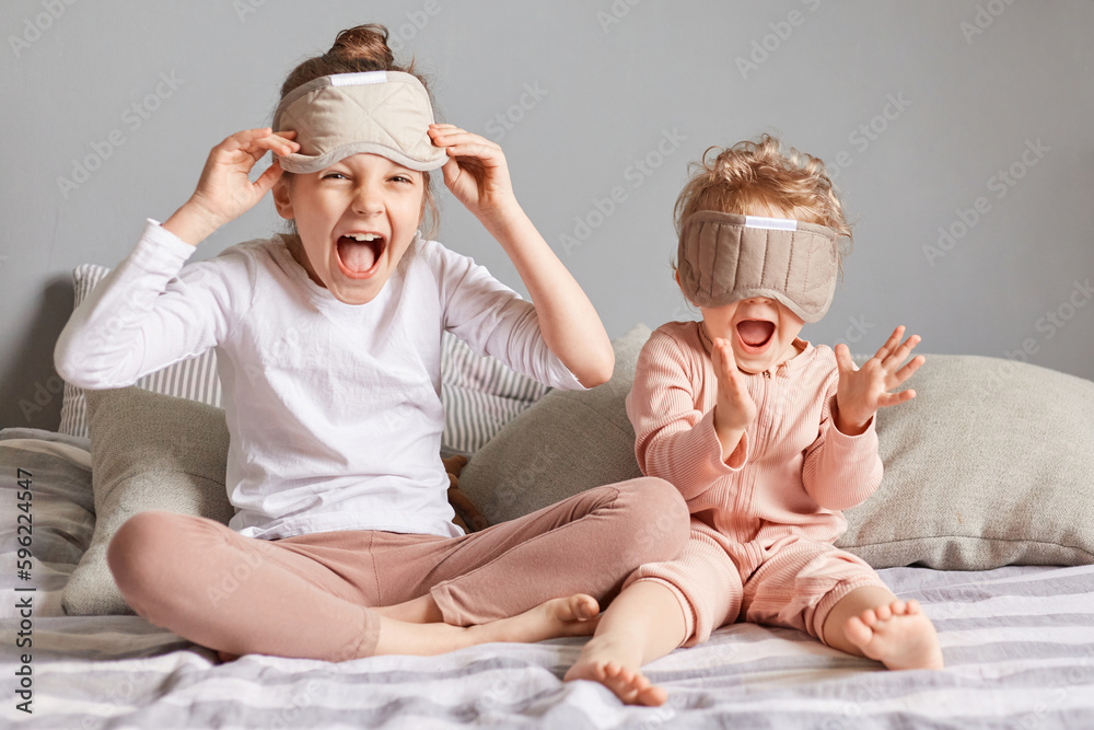 Portrait of crazy funny little girls playing in bedroom, sisters with ...