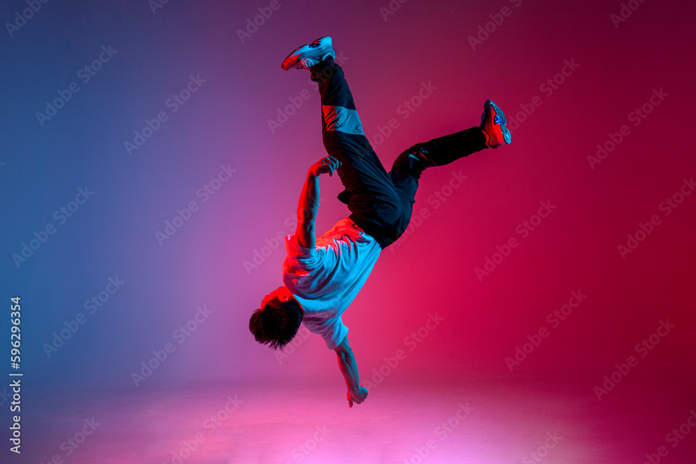 guy acrobat doing back fat in new lighting, male dancer jumps and falls ...