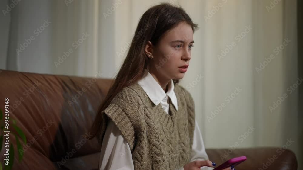 Side view teenage girl scrolling social media in smartphone app looking ...