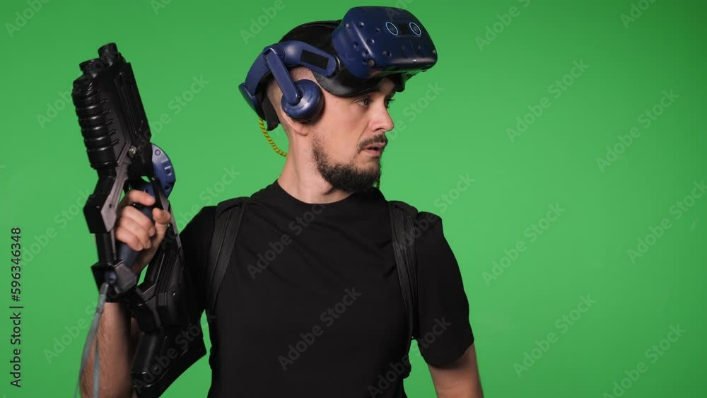 A man in a VR headset for video games with a backpack, glasses and a ...