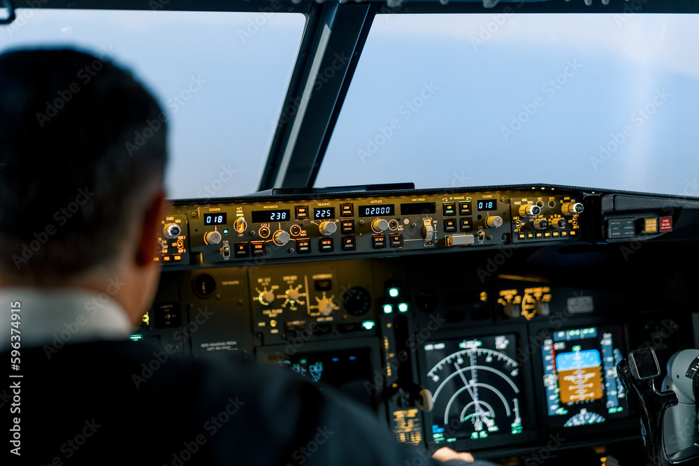 The pilot in the cockpit of the aircraft turbulence during the flight ...