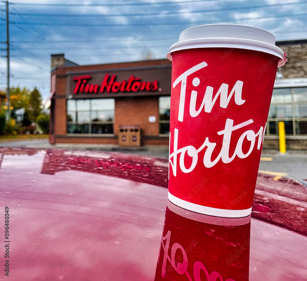 oshawa, canada - 19 October 2022: cup of tim hortons coffee on red car ...