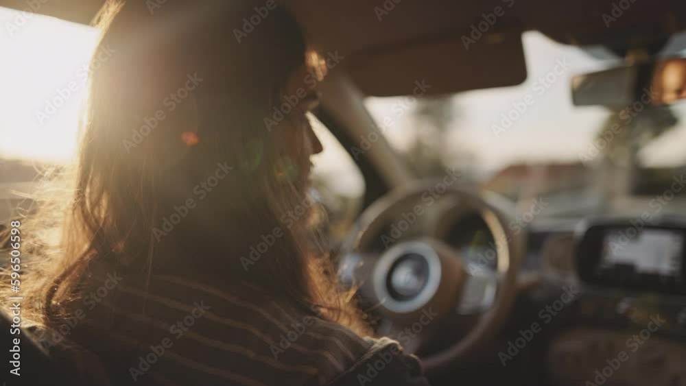 Man driving a car at sunset. Unrecognizable male driver holding ...