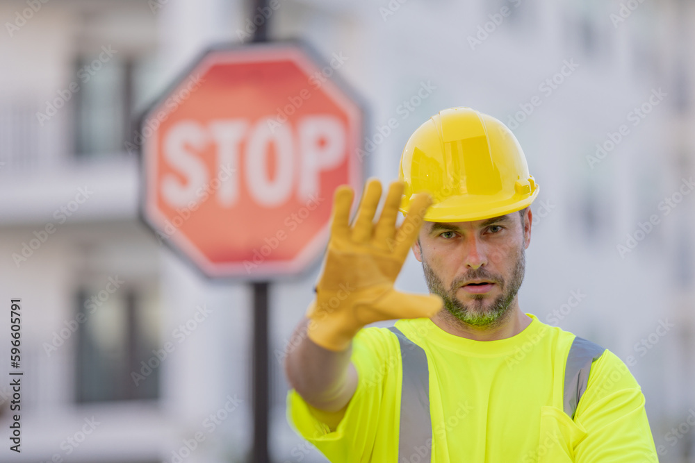 Serious worker with stop road sign. Builder with stop gesture, no hand ...