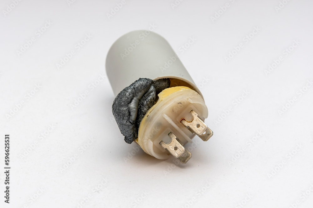 Faulty, plastic starting capacitor from the electric motor was torn on ...