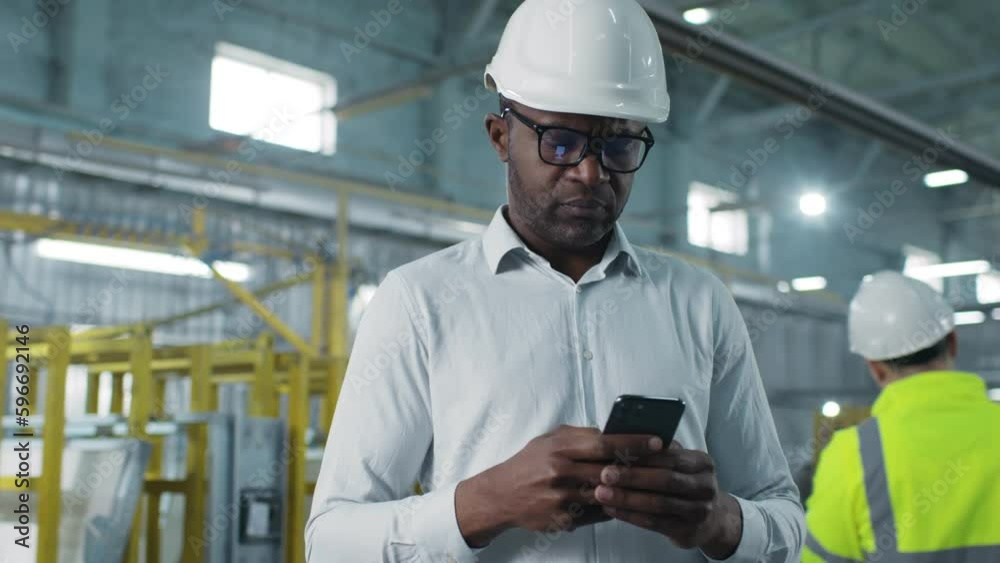 Careful concerned hard-working African-American male wearing white ...