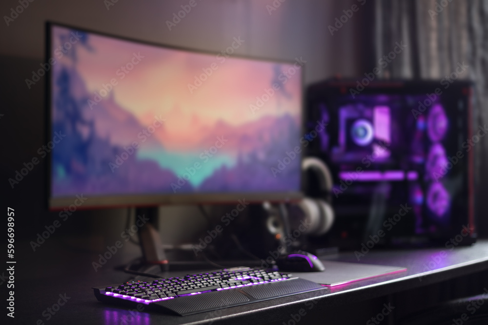 Modern gaming desktop setup, RGB lights, widescreen monitor and water ...
