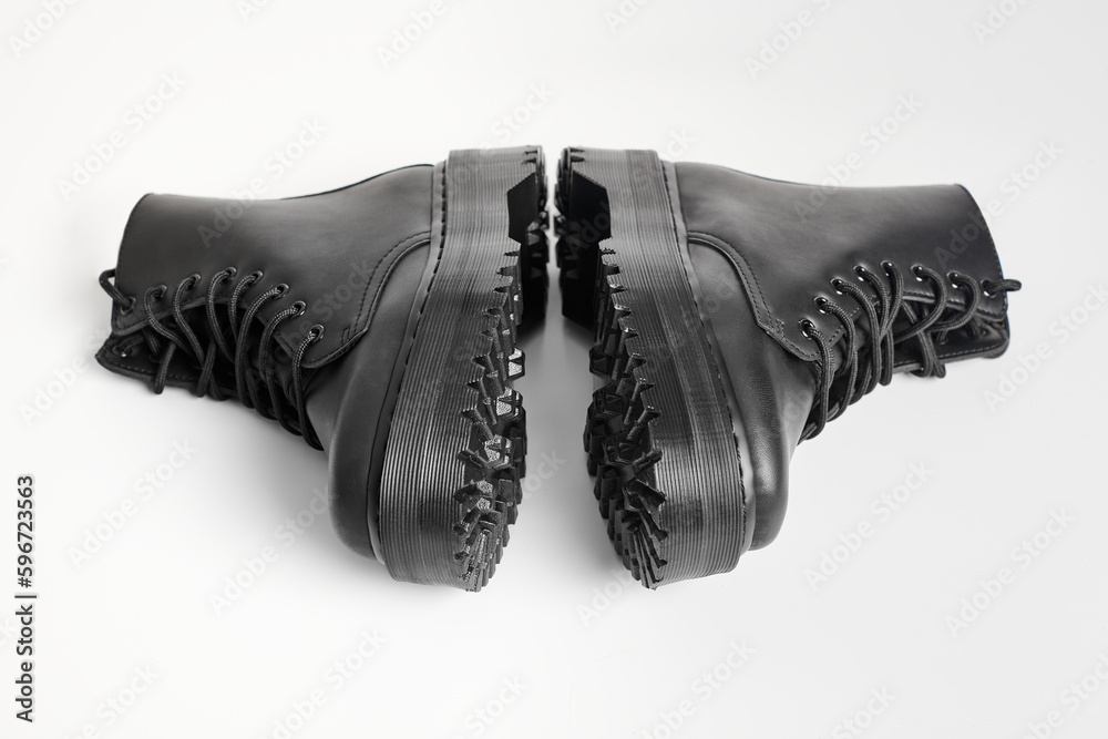 Black women combat boots on high heel platform with lug soles lying on ...