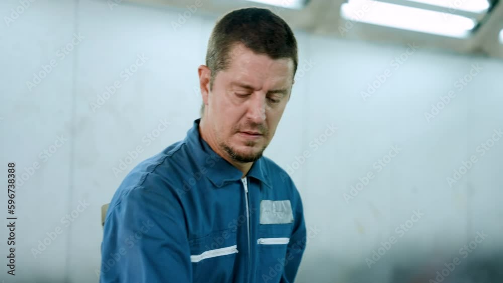 Close-up male mechanic's face Wear mechanic's uniform for work safety ...