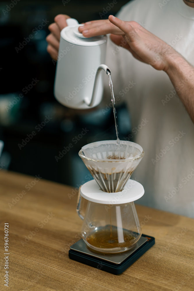 The process of making filter coffee by pouring hot water over a layer ...