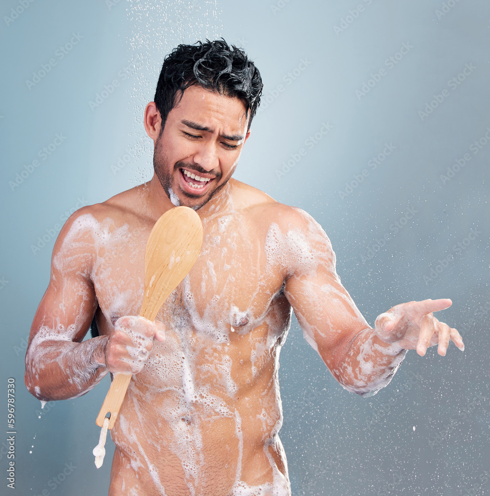 Handsome young man singing in the shower. Happy mixed race male holding ...