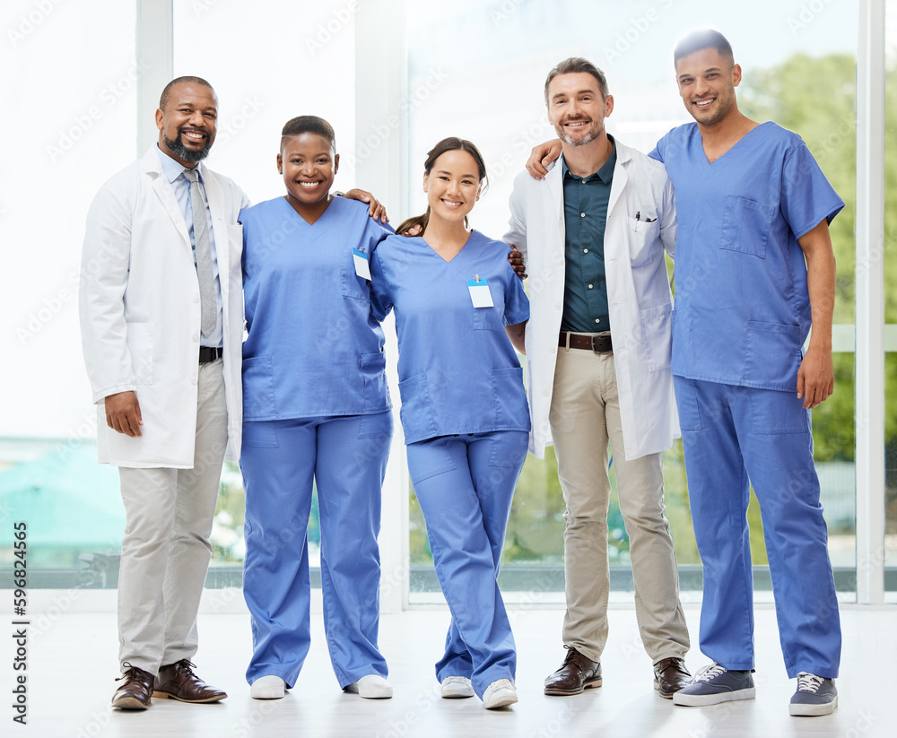 Together they save lives. Shot of a cheerful group of doctors standing ...