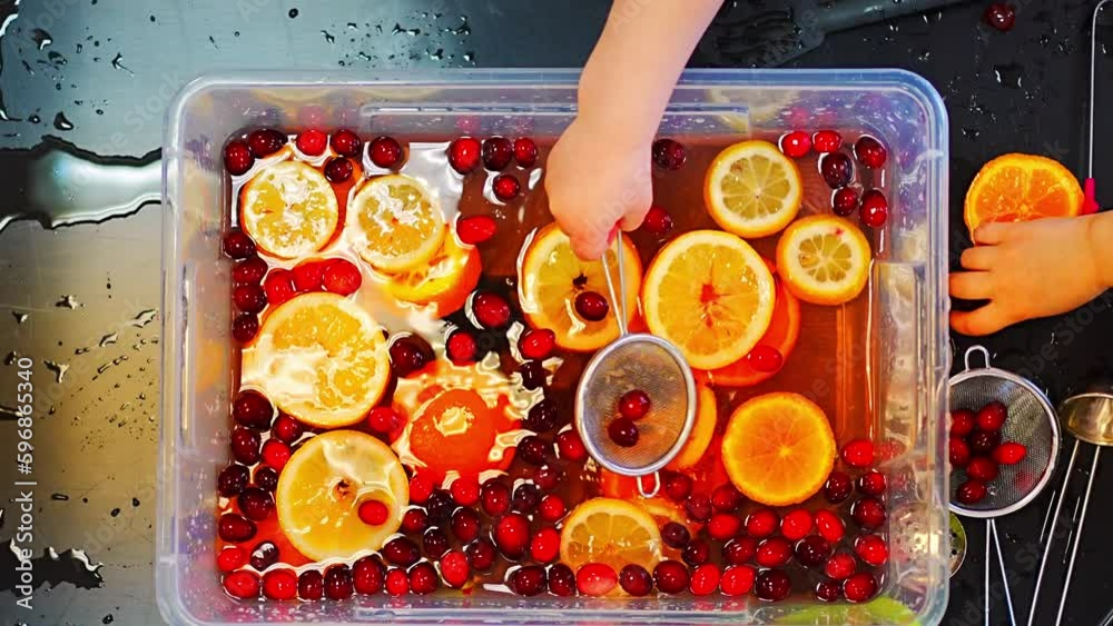 Kids playing in handmade fruit bar with kitchenware, berries and citrus ...