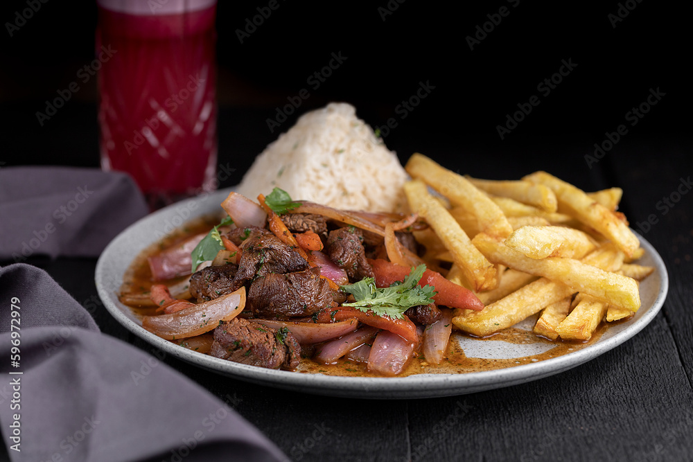 Lomo saltado con papas fritas y arroz blanco peruvian food Stock Photo ...