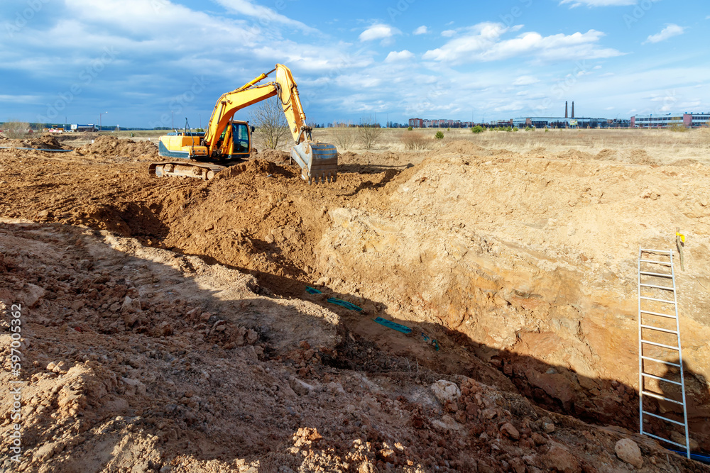 Excavator dig the trenches at a construction site. Trench for laying ...