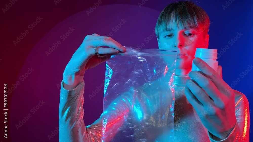 Serious young woman blank expression pouring pills out packer bottle ...