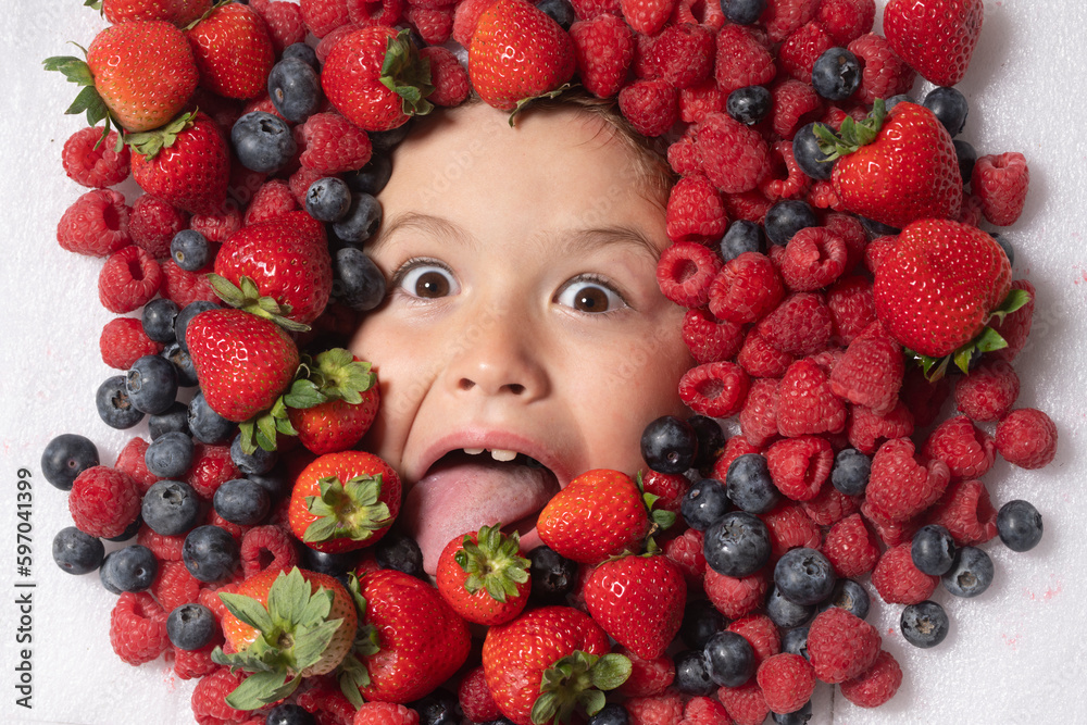 Kids face with close-up berry. Berries mix of strawberry, blueberry ...