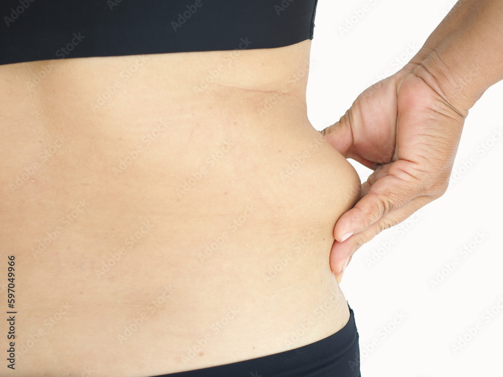 Cellulite and belly fat in woman, She grabbing her abdomen near waist ...