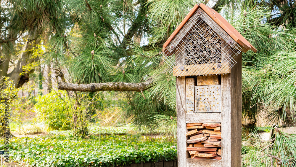 Insect hotel with many houses made of natural materials for various ...