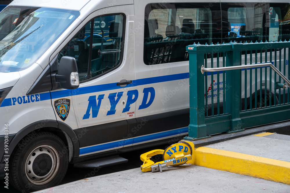 NYPD New York Police Department van and bright yellow car boot with ...