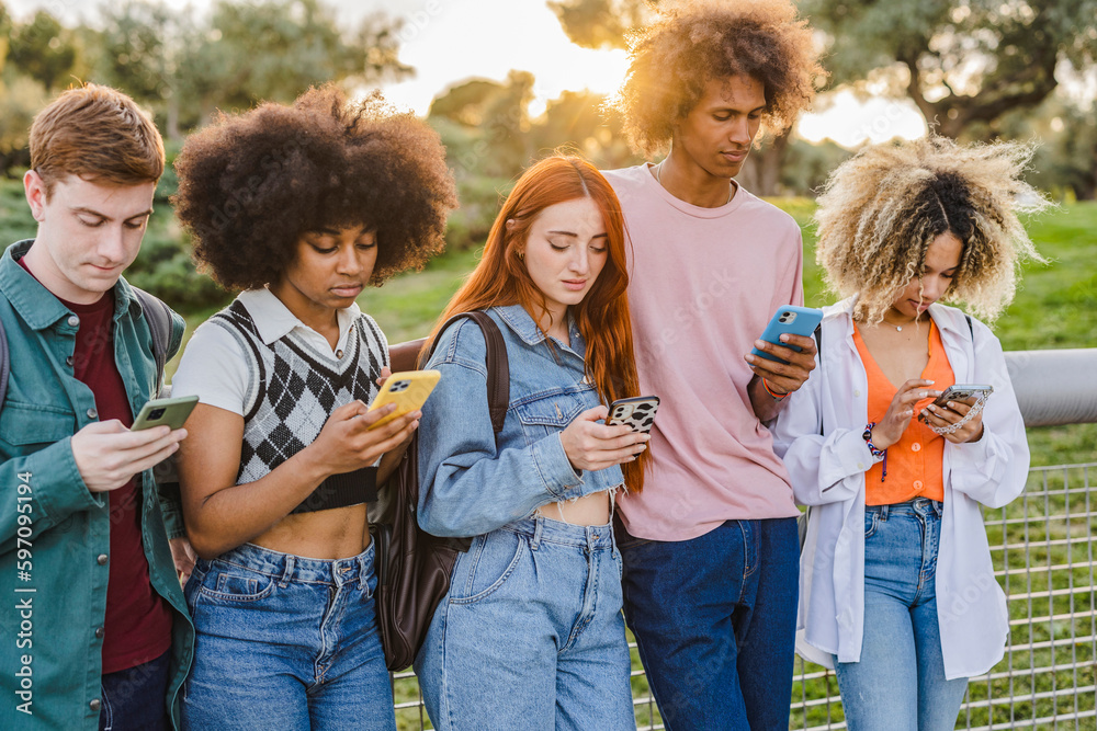 Group of generation z friends together using mobile phones to share ...