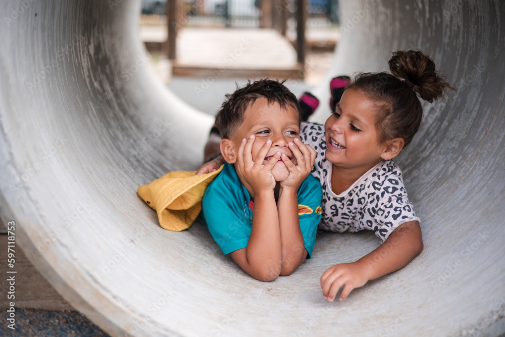 Young First Nations girl and boy playing together in a tunnel Stock ...