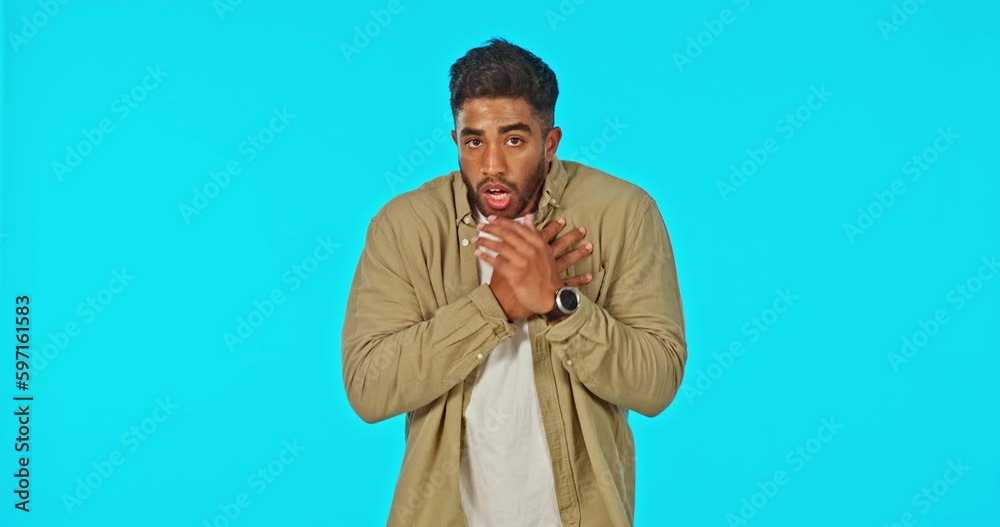 Scary, face and a man with fear of a hit isolated on a blue background ...