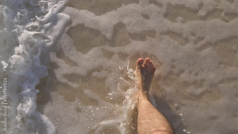 Top view feet walking on the sand of the sea coast. Male legs walking ...