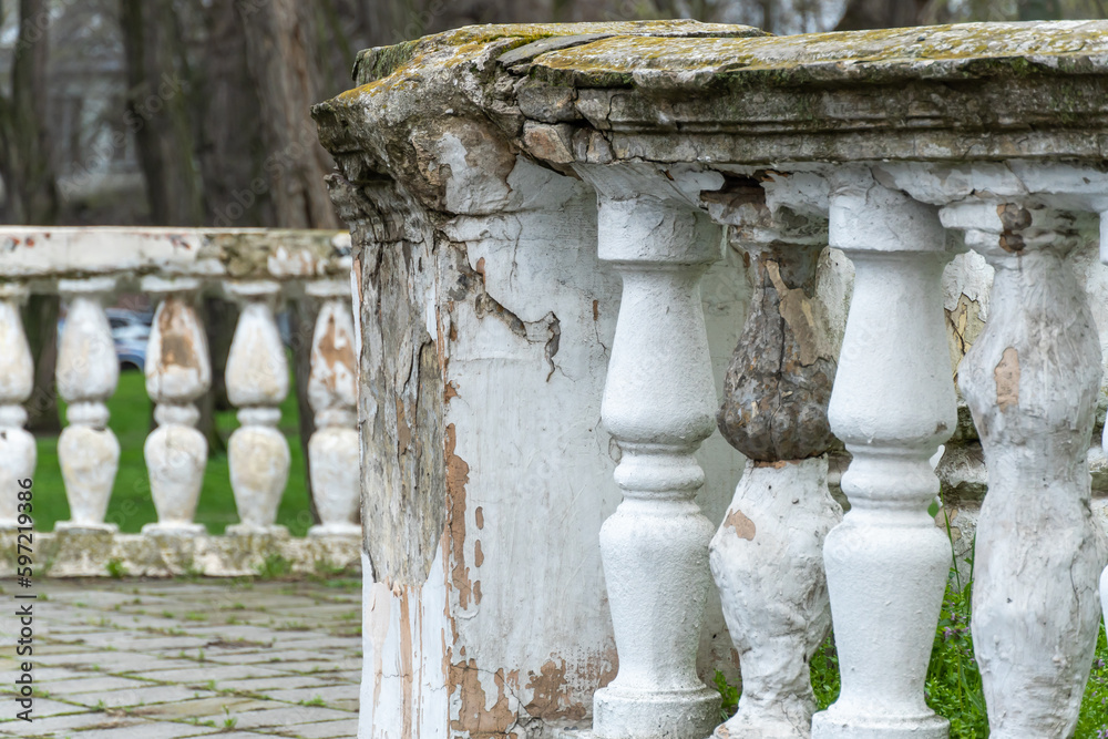 Row of ancient stone railings in city park close up. Ruined long of ...