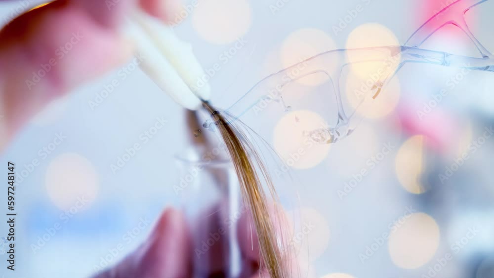 Vidéo Stock laboratory assistant examines hair sample, curls in package ...