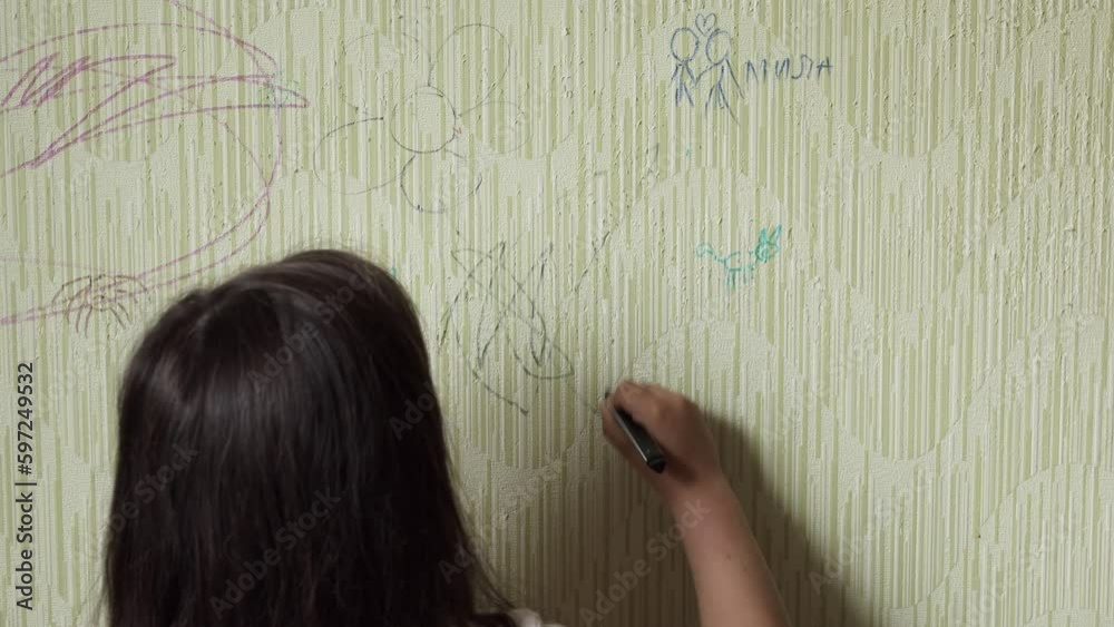 Black haired little girl emotionally draw doodle with dark colored ...