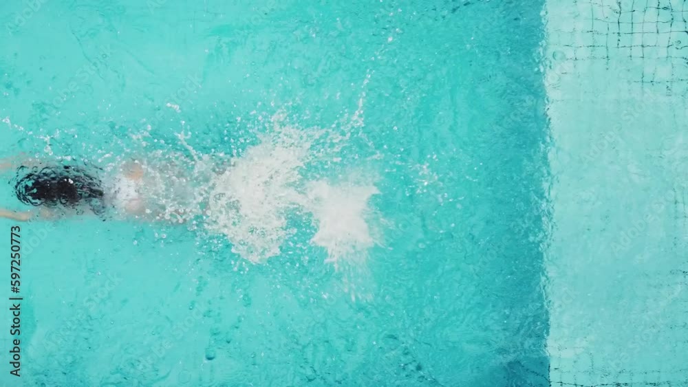 Aerial view of Active woman, girl jumping in swimming pool, drone view ...