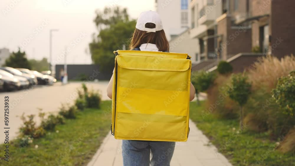 Back View of the Caucasian Lady Courier Carrying the Yellow Backpack ...