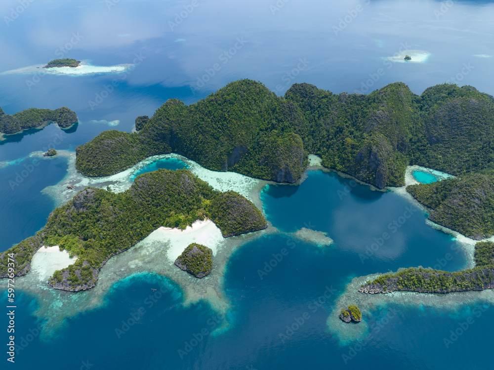 Beautiful coral reefs surround the dramatic limestone islands that rise ...